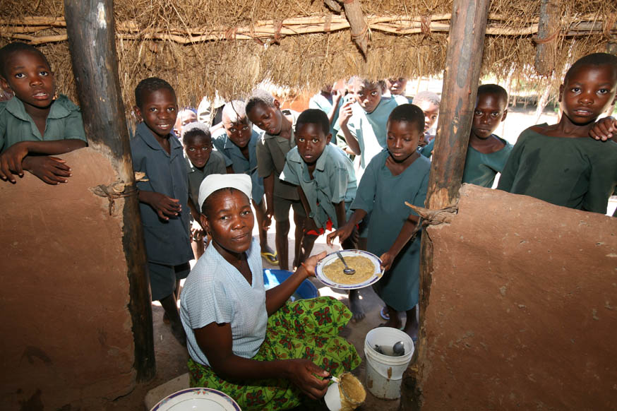 Students wait in line for lunch in Ngoma School, Sikaneka village ...