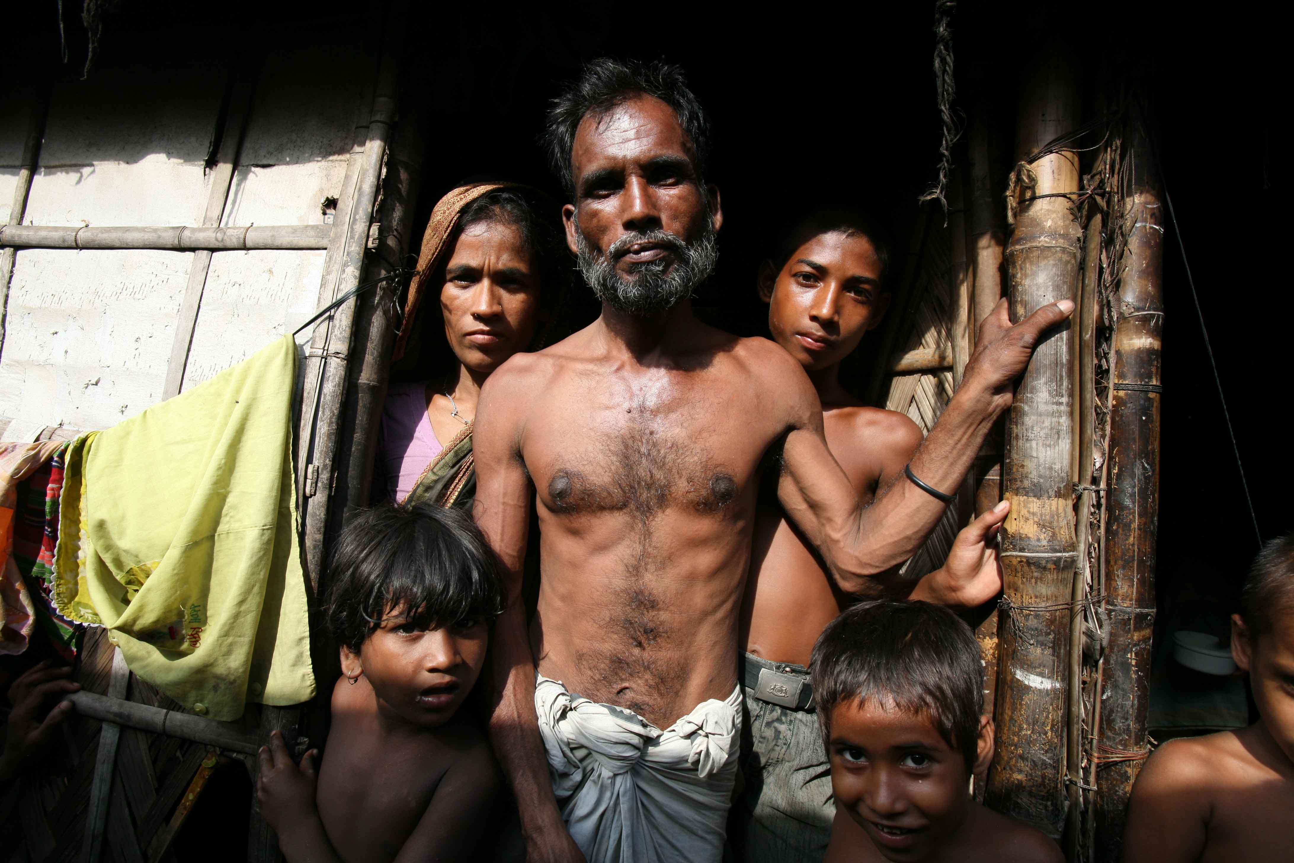 A Dhaka slum family stands outside their home, Bangladesh, July 2007 ...
