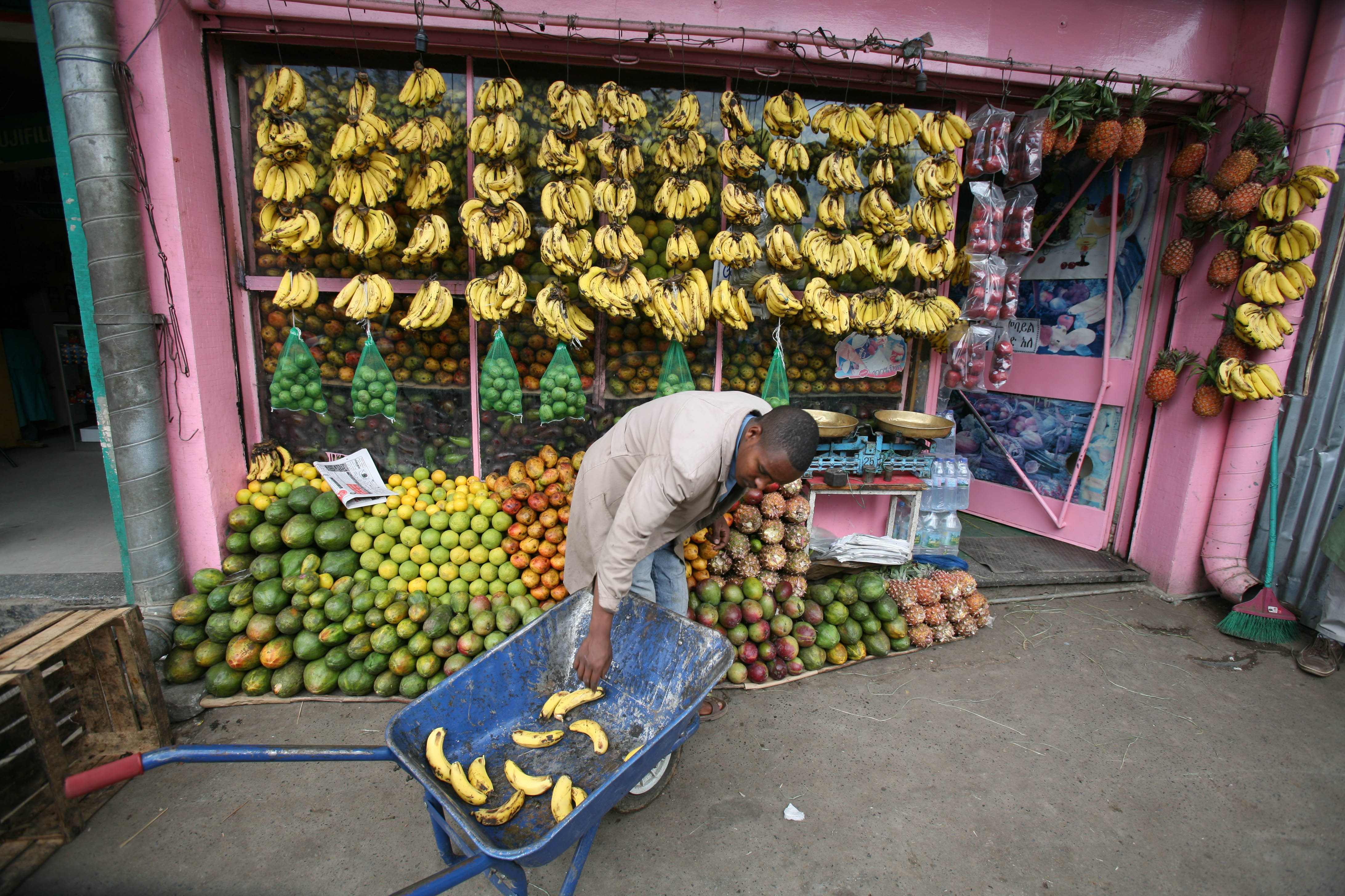 A fruit vendor preparing his stall in Merkato market, Addis Ababa ...