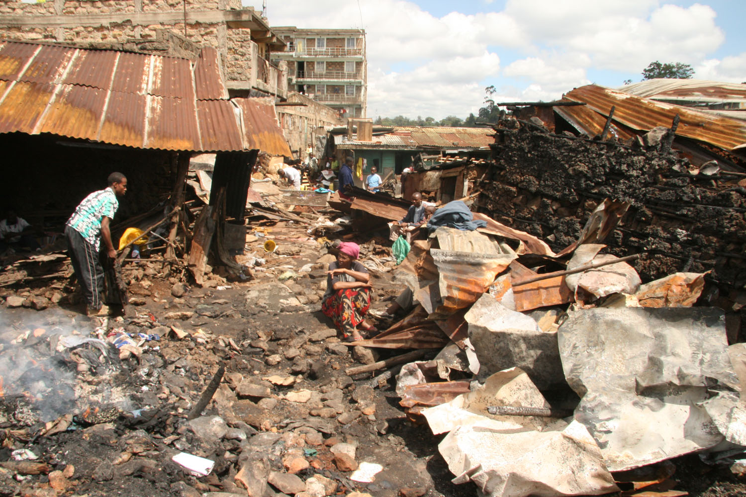 Residents of Mathare slum, Nairobi, Kenya, April 2008, try to salvage ...