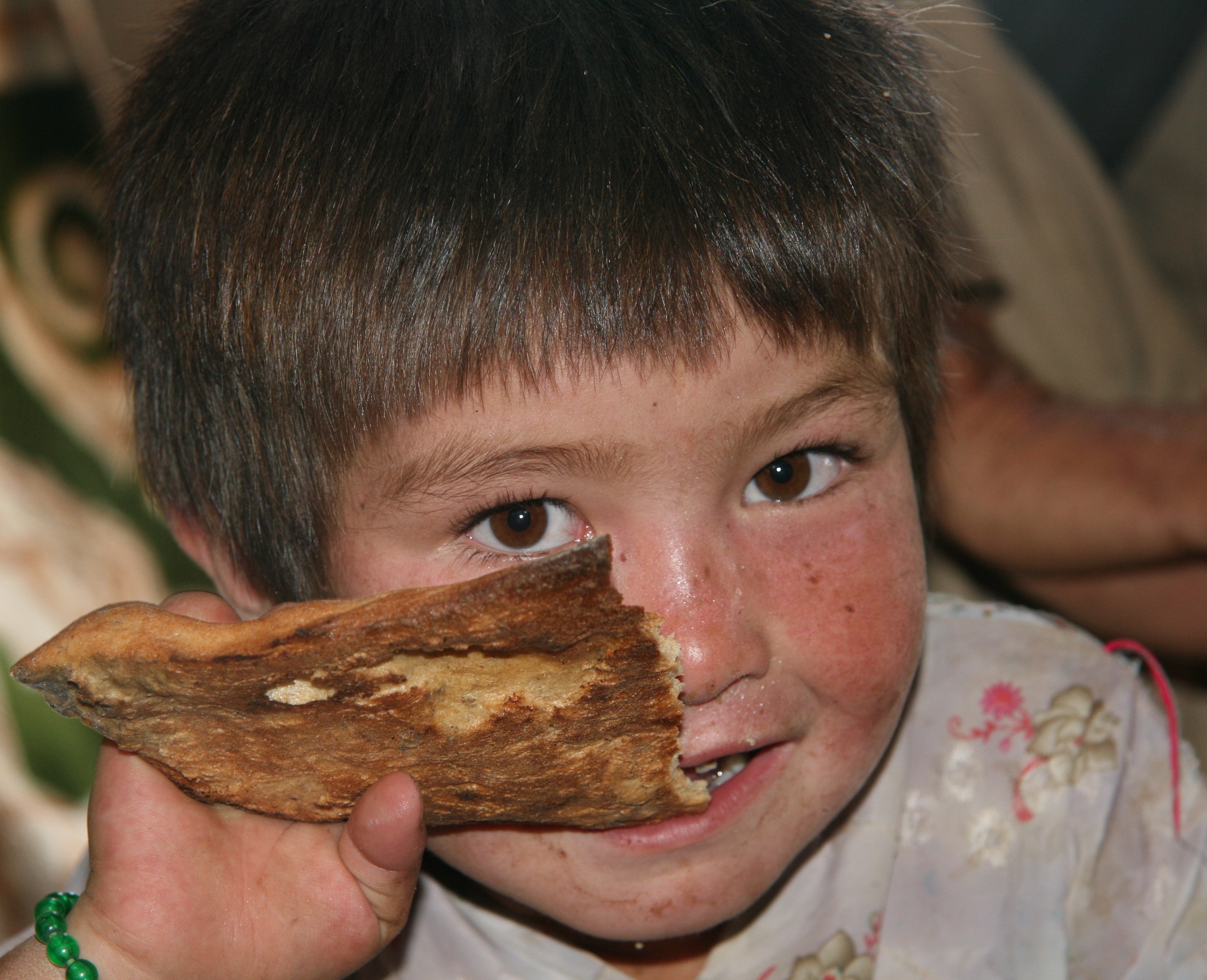 5-year-old Fatima is eating the only piece of flat bread provided by ...