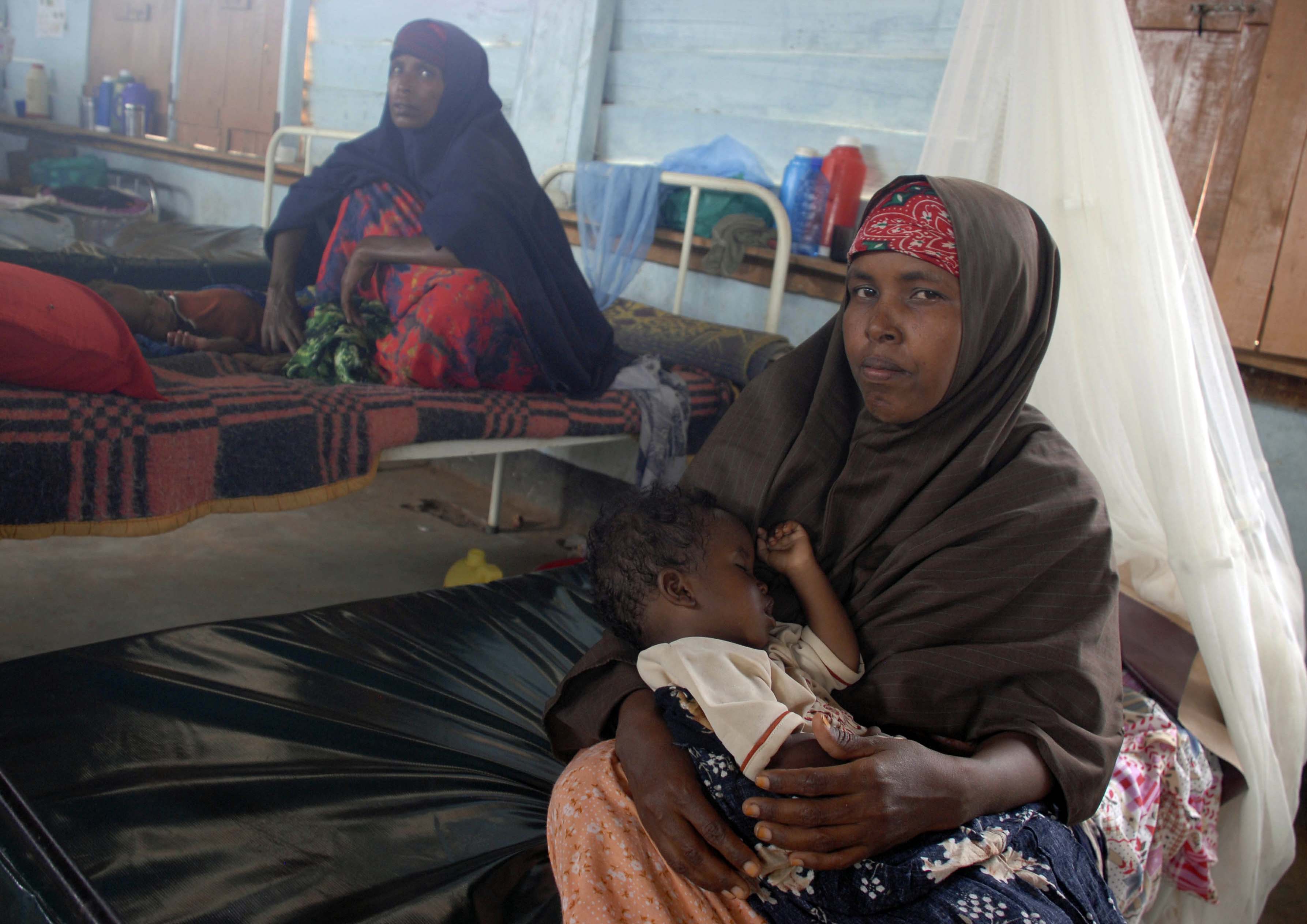 Patients at the Daadab refugee camp nurse their children in one of the ...