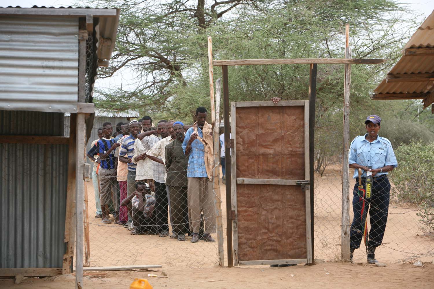 Somali refugees queue up outside the gate of the UNHCR compound prior ...