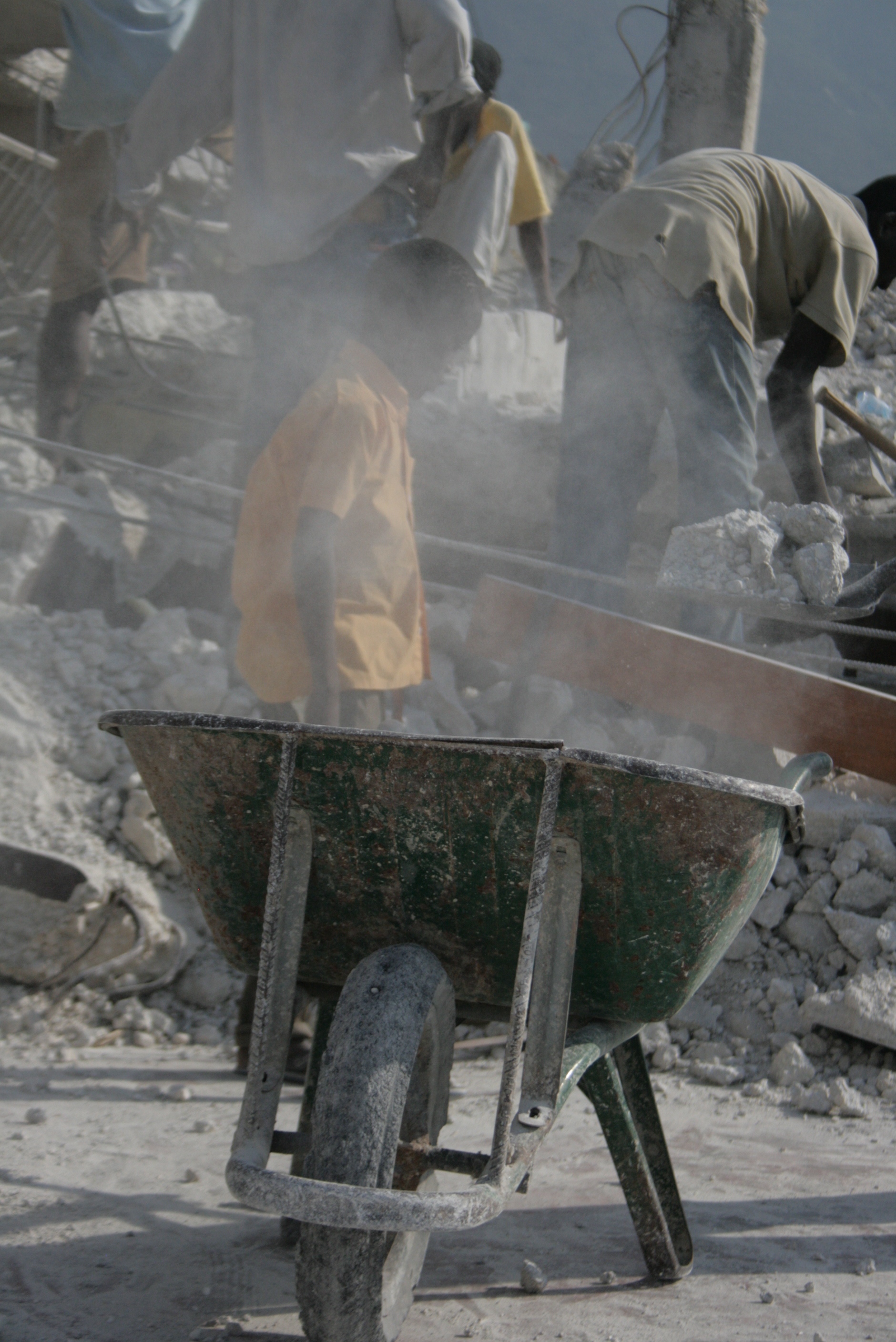 Youths clean up earthquake rubble of a church/school building in Port ...