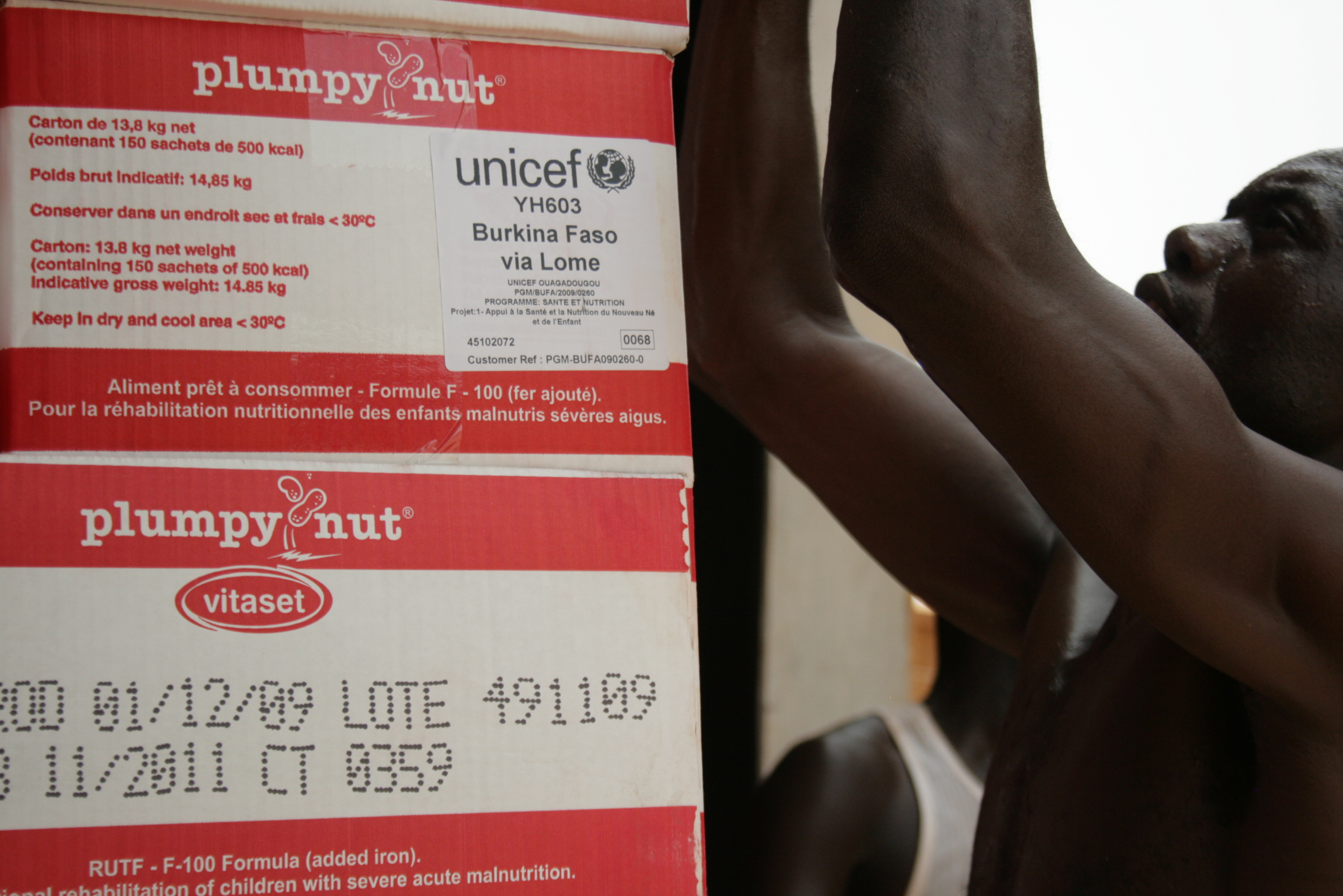 Young men in the Burkina Faso capital Ouagadougou loading Plumpy Nut ...