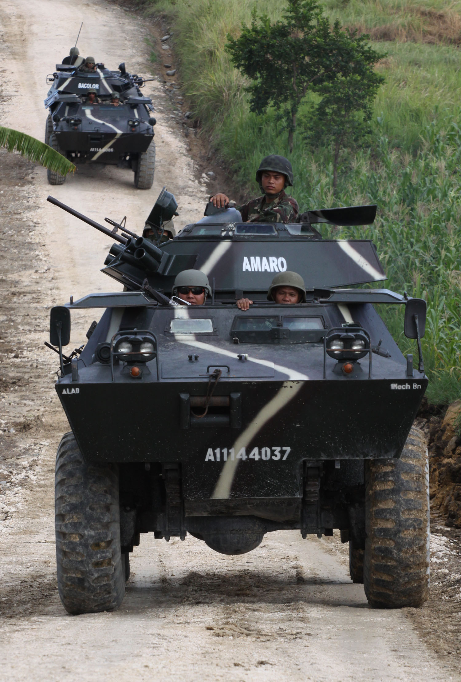 Military tanks patrol a hill area in the southern Philippine province ...