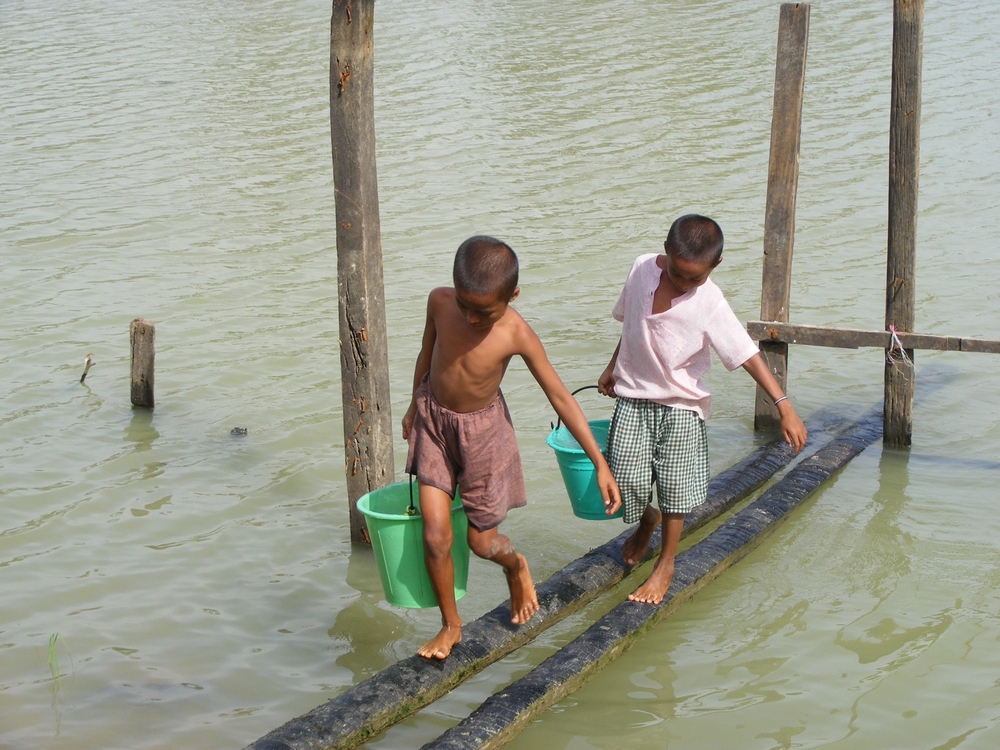 Boys fetching water from a communal water pond in Patpel Village in ...